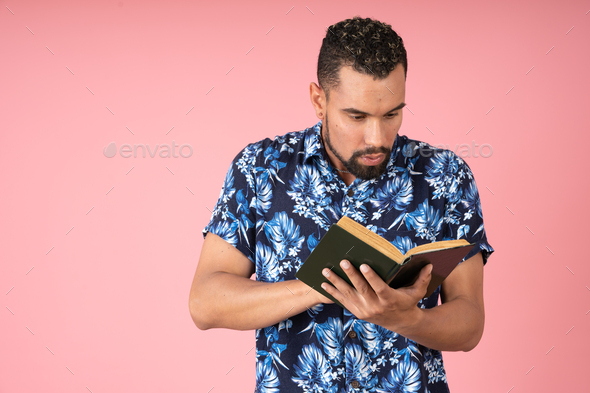 Surprised and emotional man while reading an antique book Stock Photo ...