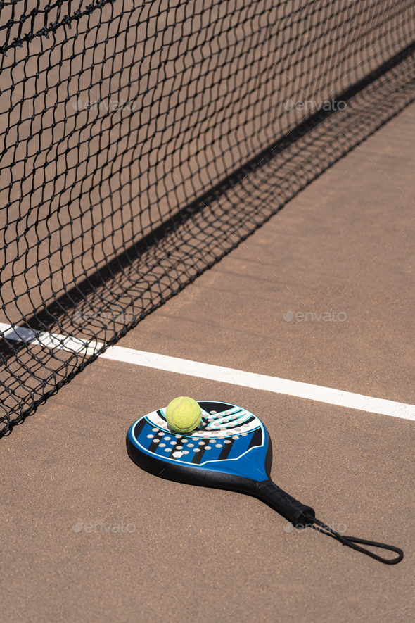 Padel racket and balls on court Stock Photo by diignat | PhotoDune