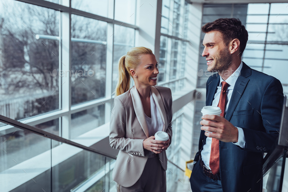 Socializing with coworker during office break Stock Photo by bernardbodo