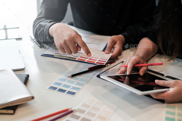 Two young team of ui ux designer planning and analyze applications on ...