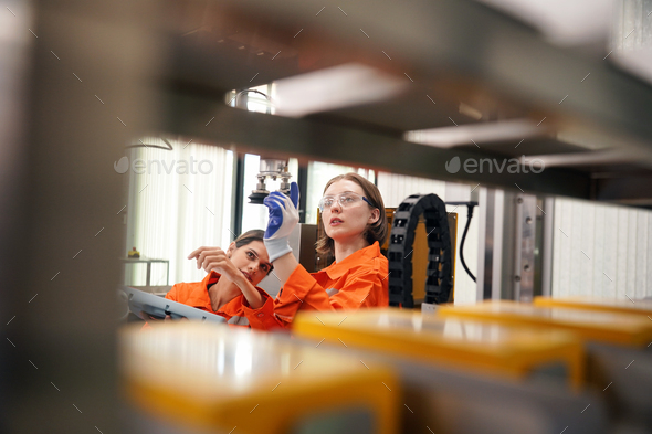 Robotics control engineers solve problems and setting programming of ...