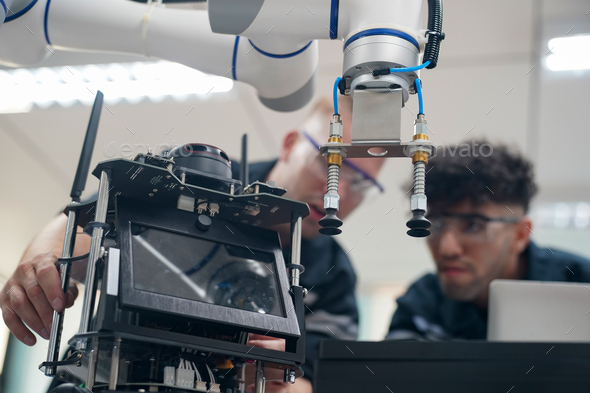 Robotics control engineers setting programming of control panel for ...