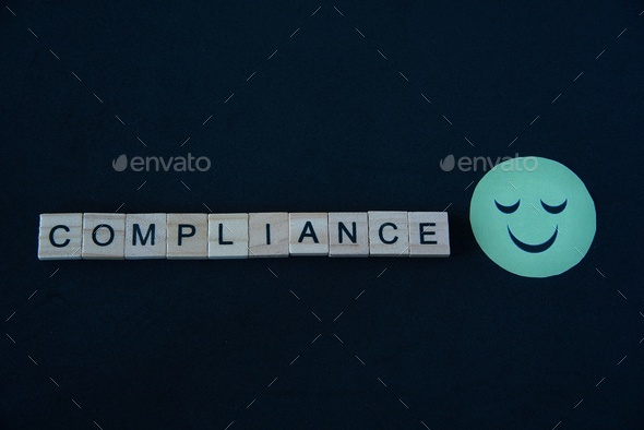 Compliance written in wooden letters next to smiley emoji. Stock Photo ...