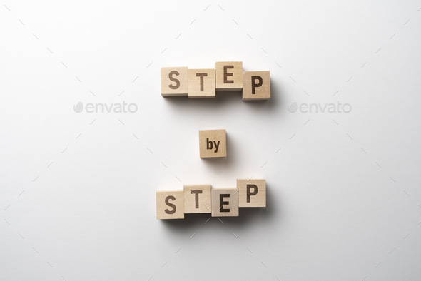 the wooden cubes blocks with "step by step" text, personal growth ...