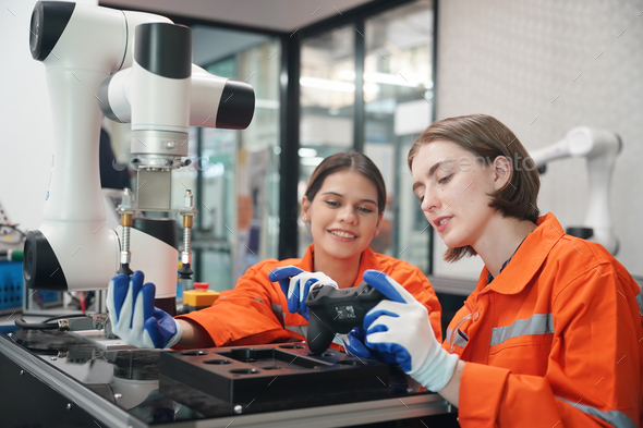 Robotics control engineers setting programming of control panel for ...