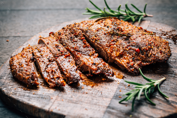 Grilled beef steak with spices on cutting board Stock Photo by Brebca