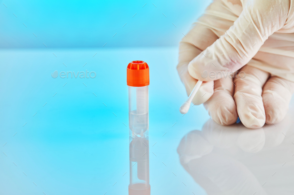 DNA test. Test tube with liquid for DNA analysis and a gloved hand ...