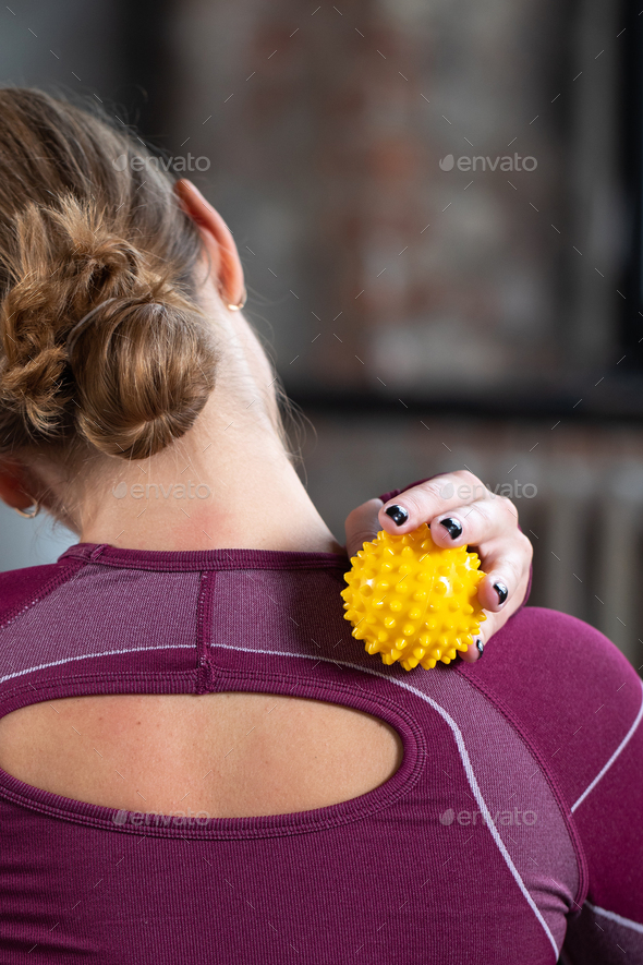 The athlete does a relaxing massage of the neck and back with the help ...