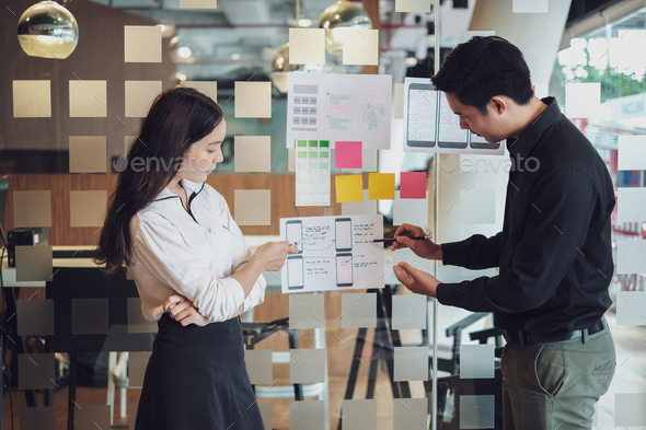 Two young team asian people of ui ux designer planning and analyze ...