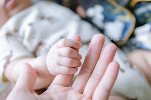 Newborn baby holding parent's hand, baby hand Stock Photo by Kenstocker