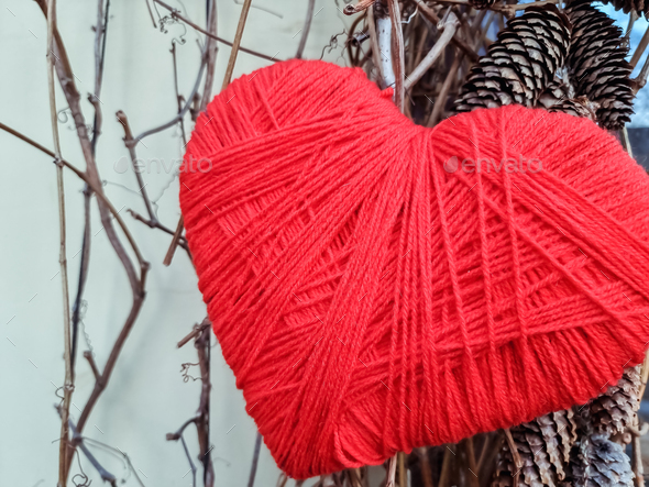 heart shape symbol made from wool.Red knitting yarn heart shaped ...