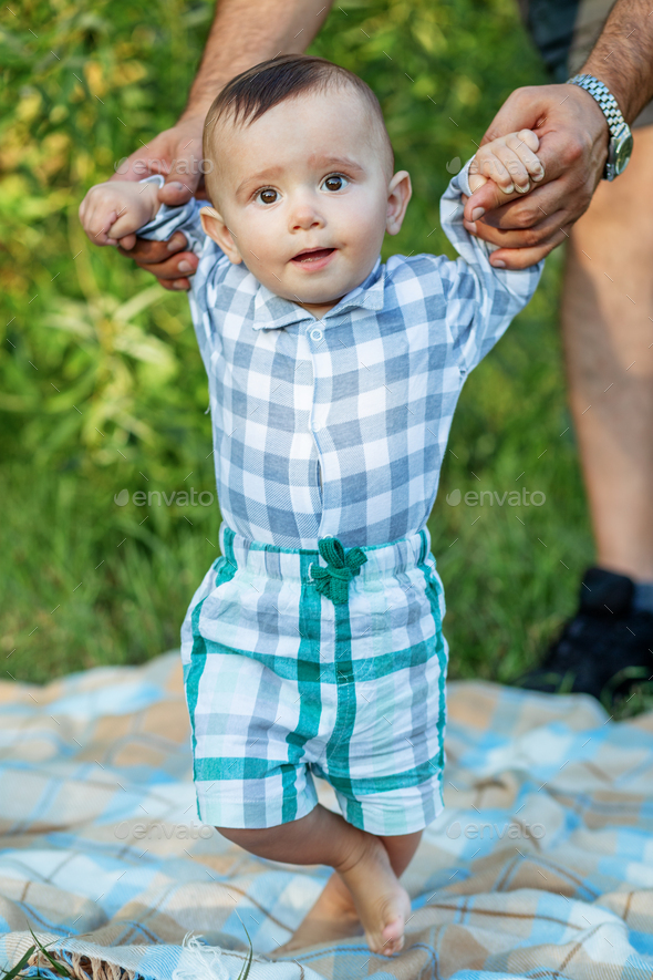 Walking toddler concept - little baby child boy making first step ...