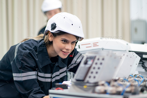 Engineer Man working at industrial robot in factory industrial. robotic ...