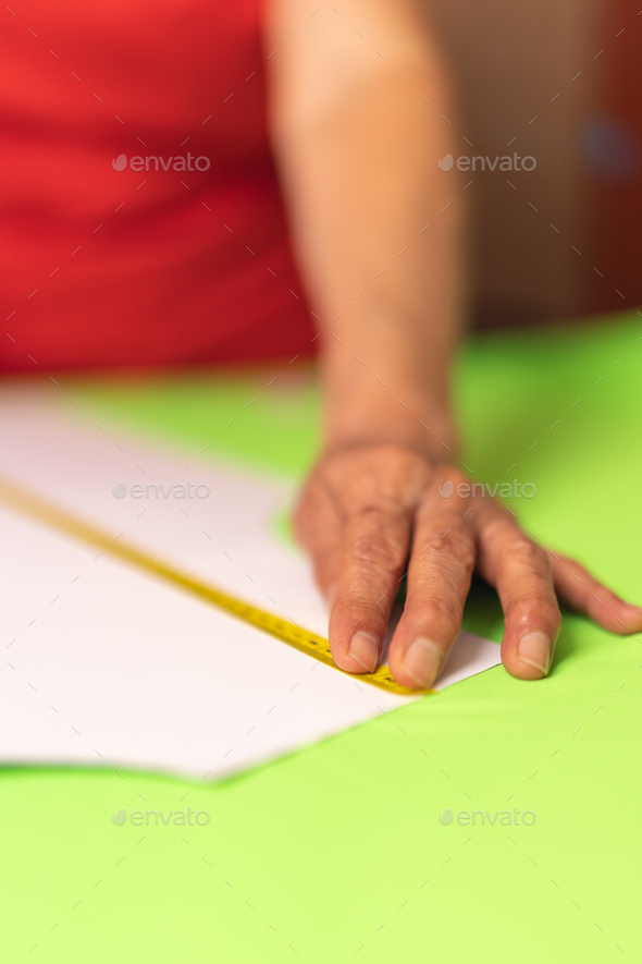 woman's hand taking measurements on a cutting table in a workshop Stock ...