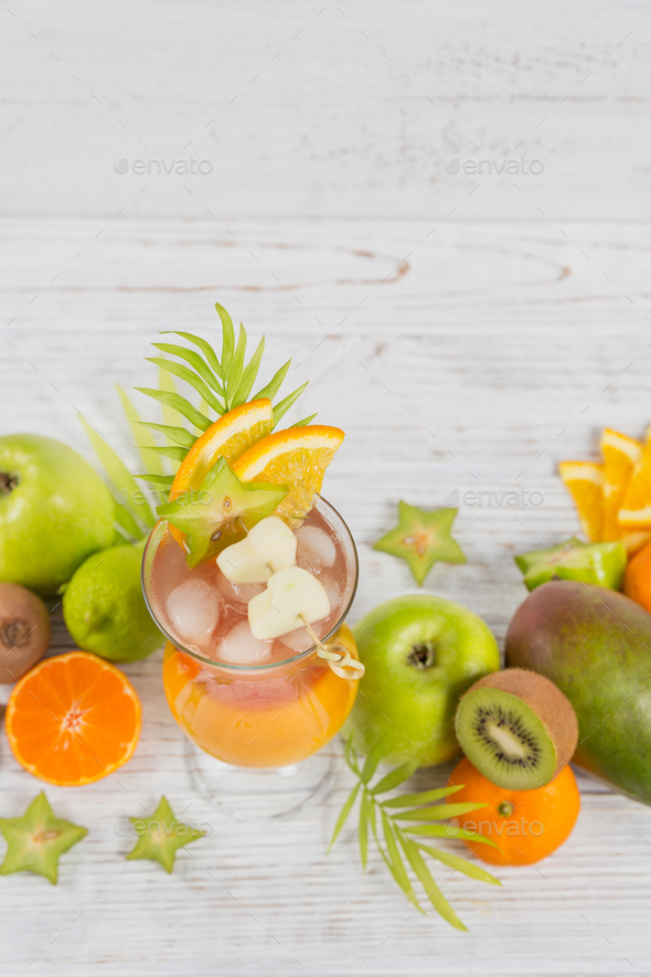 Summer cocktail with various tropical fruits around. Stock Photo by ...