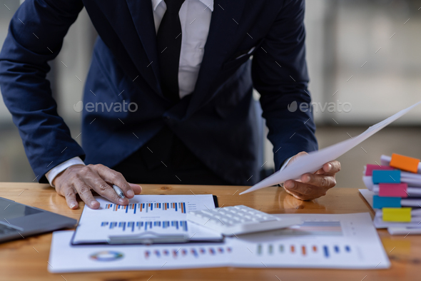 Businessman accountant or financial expert analyze business report ...