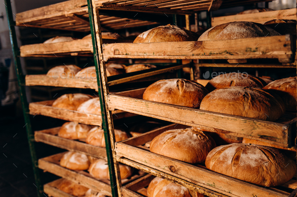 freshly baked bread on a cart at the bakery Stock Photo by fentonroma