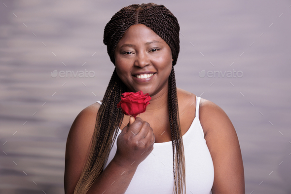 Beautiful body positive woman giving red rose bud portrait Stock Photo ...