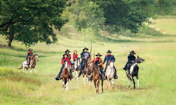 cowboy on his horse during the run of the horses in background Stock ...