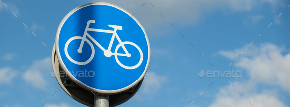 Round road sign depicting white bicycle on blue background, meaning ...