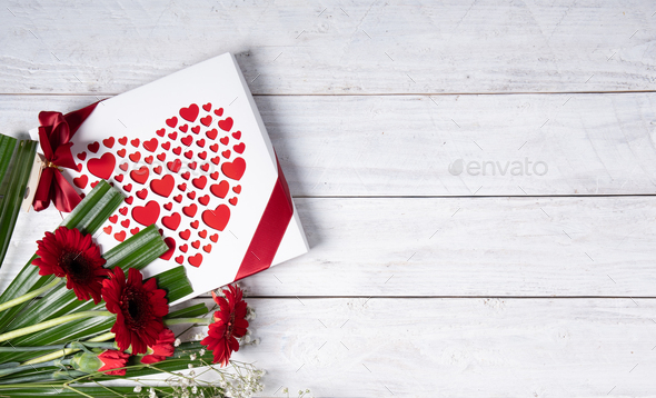 Valentine's day gift, red heart praline box and flower bouquet on white ...
