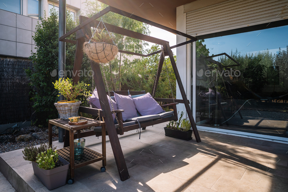 Veranda with swing in sunny weather Stock Photo by guillemd | PhotoDune