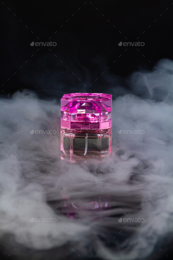 Pink bottle of womans perfume with vapor. Stock Photo by stockfilmstudio