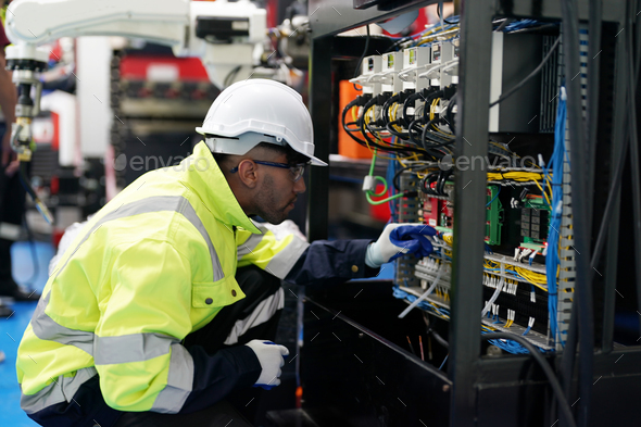 Robotics control engineers solve problems and setting programming of ...