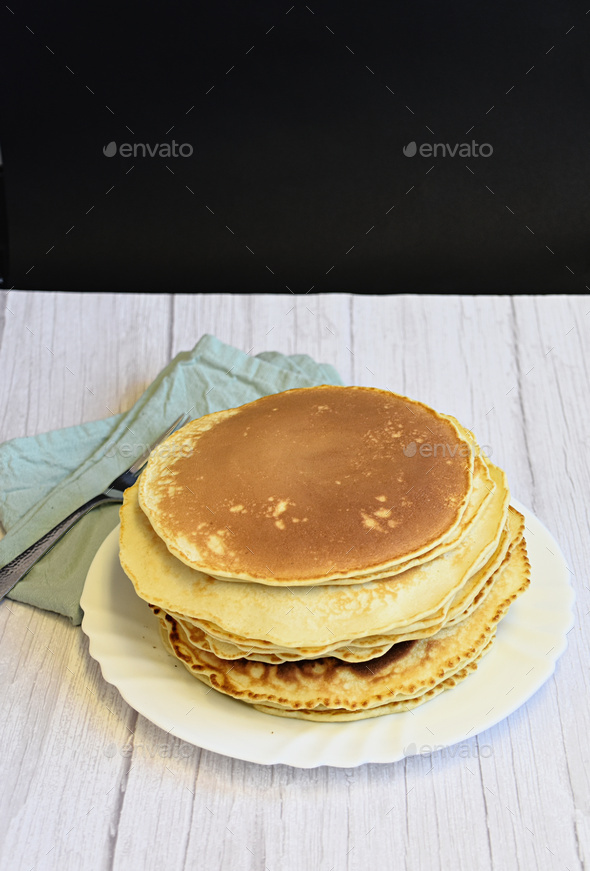plain stack of golden brown homemade pancakes with neutral background ...