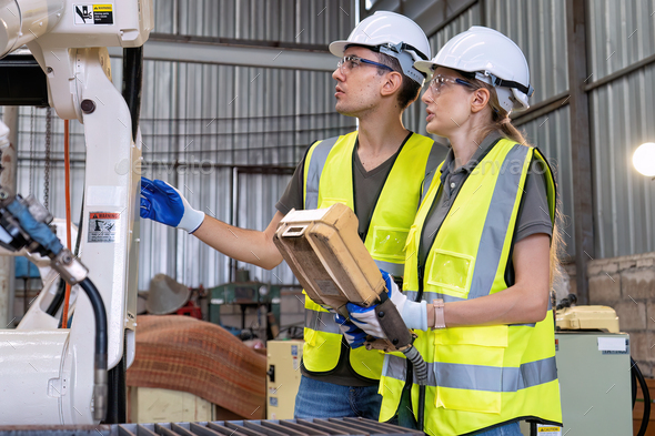 In robotic training center instructor teaching girl engineer how to ...