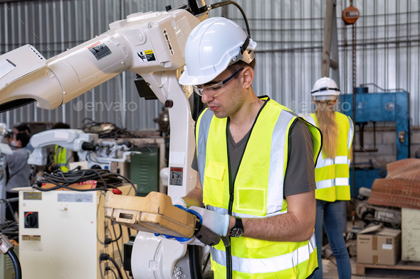 In robotic maintenance shop engineer busy commissioning and operate ...