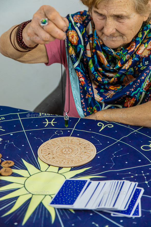 Woman fortune teller fortune telling pendulum. Selective focus. Stock ...