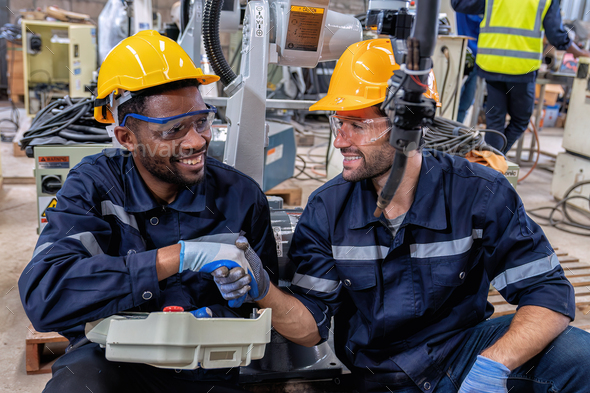 Maintenance engineer repair and programing robotic arm in factory ...