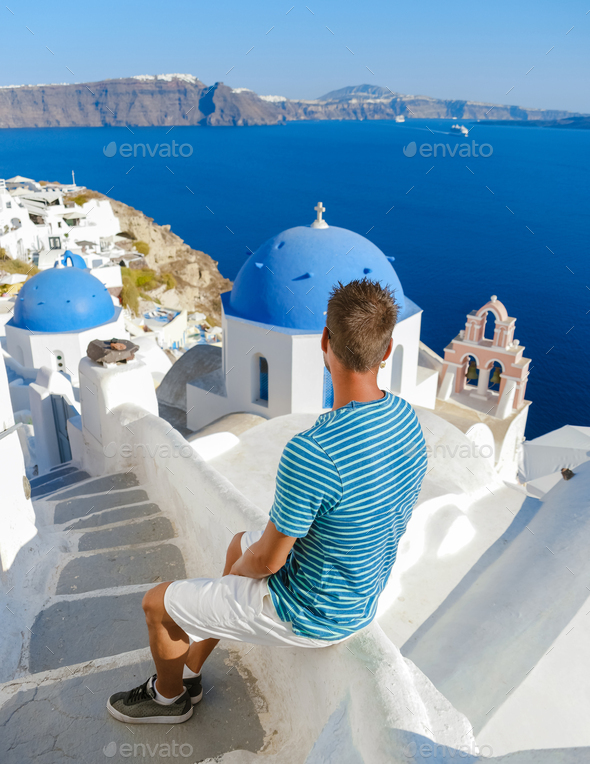 Young men tourist visit Oia Santorini Greece during summer with ...