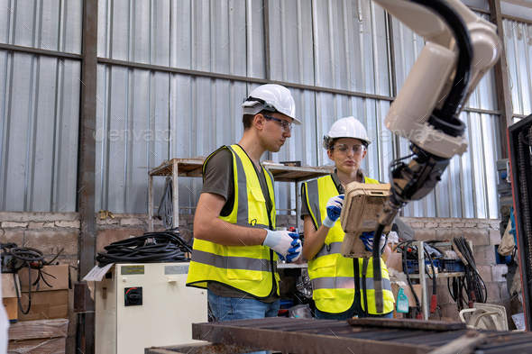 In robotic training center instructor teaching girl engineer how to ...