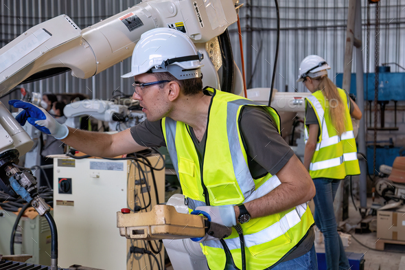 In robotic maintenance shop engineer busy commissioning and operate ...