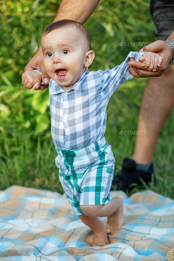 Walking toddler concept - little baby child boy making first step ...