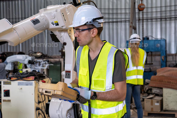 In robotic maintenance shop engineer busy commissioning and operate ...