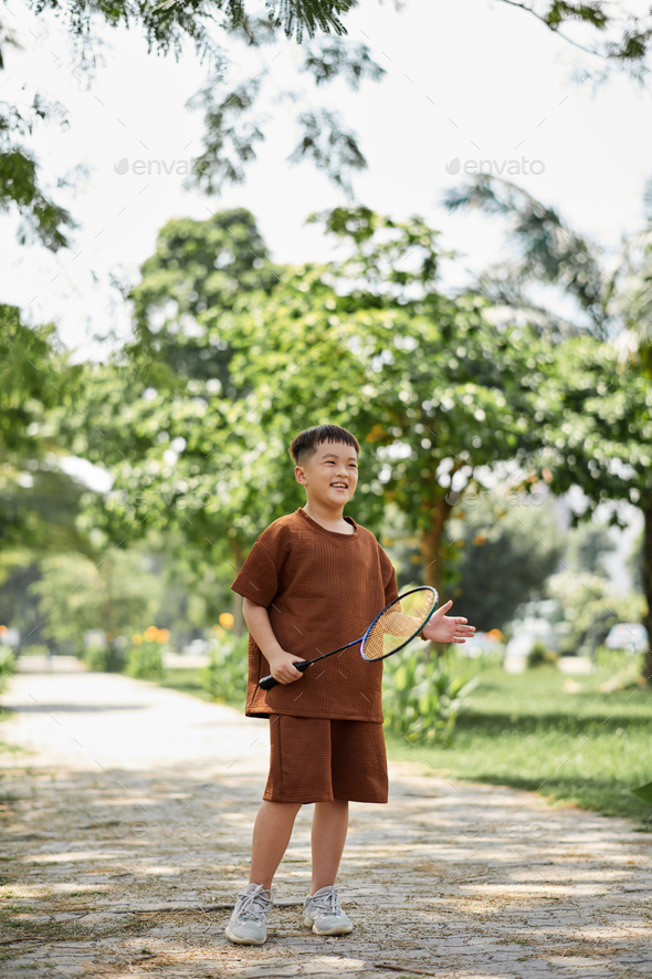 Kid Playing Badminton Stock Photo by DragonImages | PhotoDune