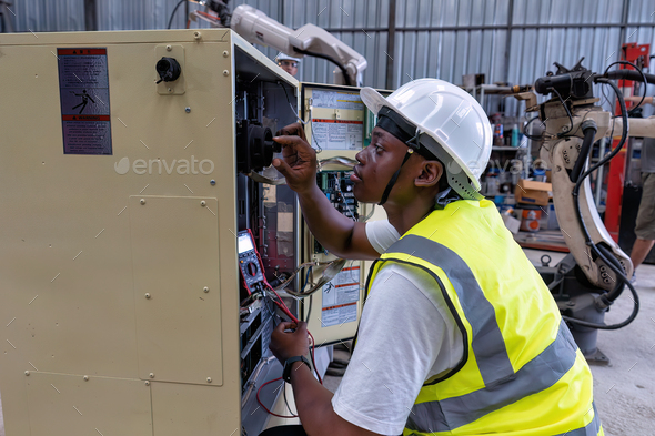 Maintenance engineer busy working checking internal wiring inside robot ...