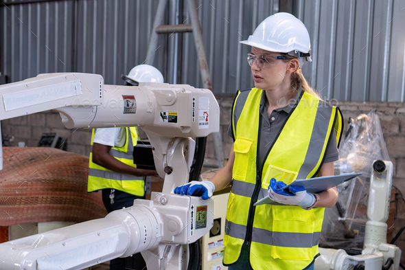 In robotic maintenance shop engineer busy commissioning and operate ...