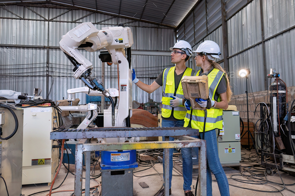 In robotic training center instructor teaching girl engineer how to ...