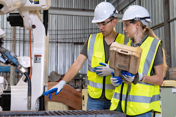 In robotic training center instructor teaching girl engineer how to ...