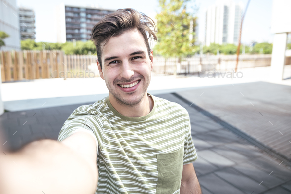 Selfie of cheerful handsome man in the campus. Portarit of happy young ...