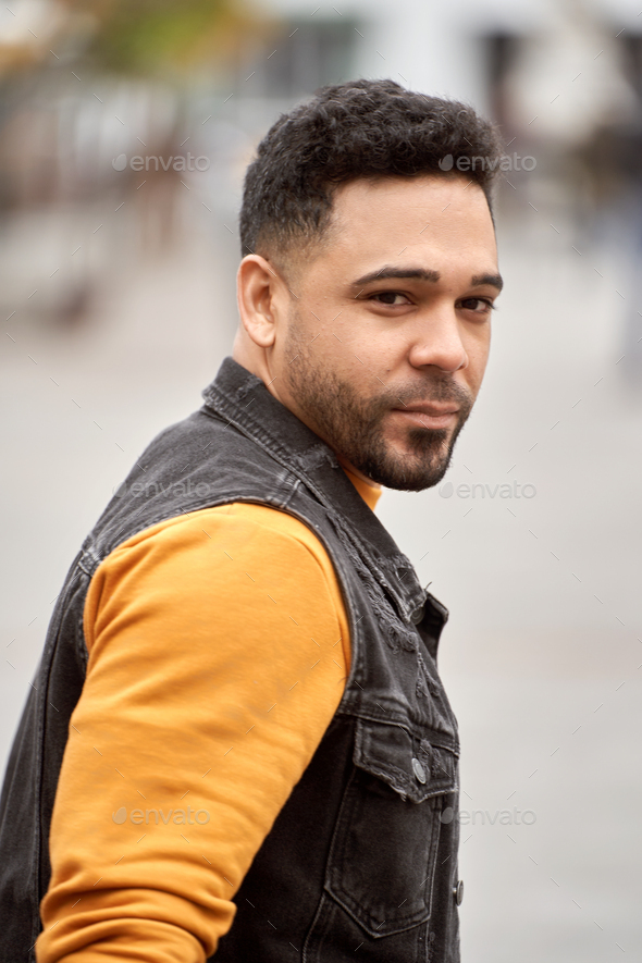 Man looking back while walking outdoors on the street. Stock Photo by ...