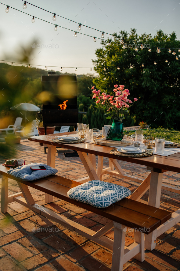 Dining table ready to serve lunch in beautiful backyard Stock Photo by ...