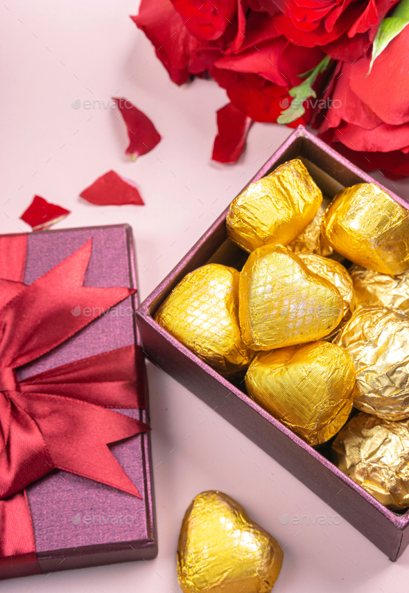 Variety of gifts and chocolates in the shape of a golden heart isolated ...