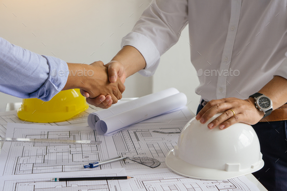 Successful deal.Engineer and contractor shaking hands success of the ...
