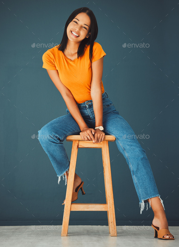 Black woman, smile and portrait of a young model sitting on a stool in ...