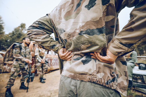 Paintball, injury and back pain by man on field for team sports ...